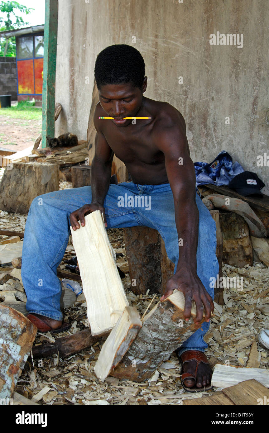 Wood carver at work at the carving centre in Aburi, Eastern Region ...
