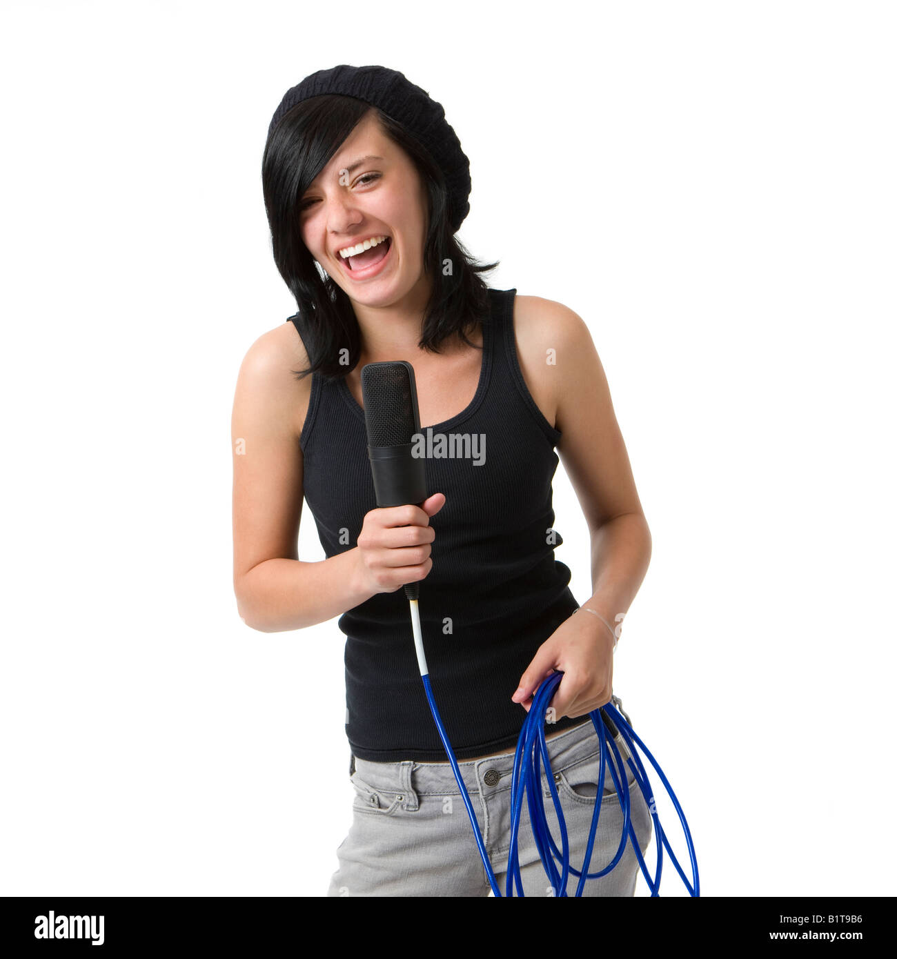 A girl with a mic smiles and sings Stock Photo - Alamy