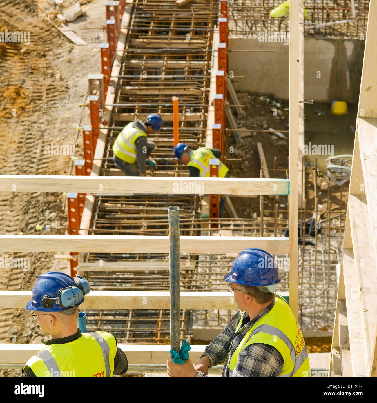 builders at work on construction site Stock Photo - Alamy