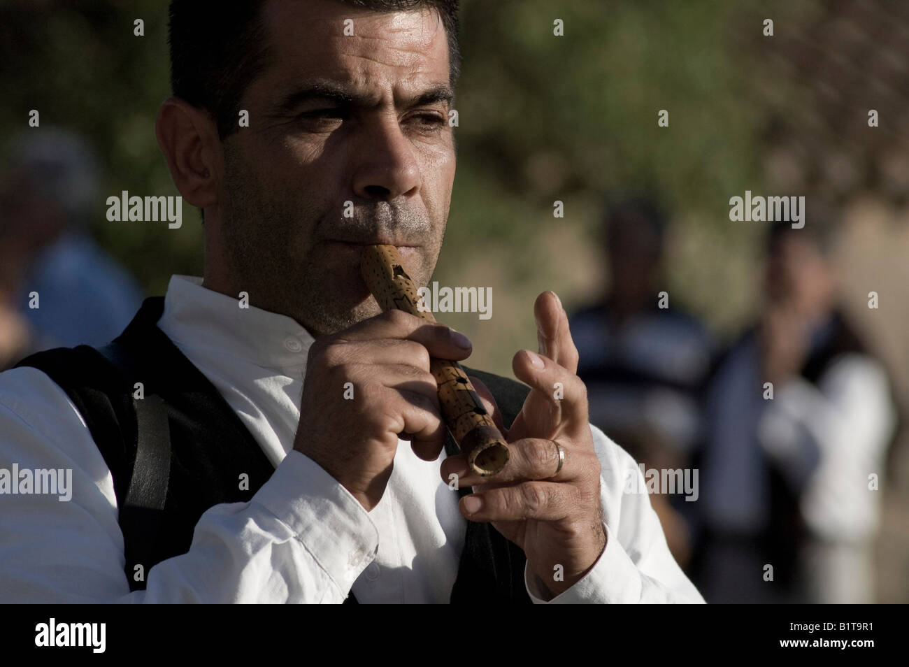 MAn playing a old flute during a local ethnical fest Stock Photo - Alamy