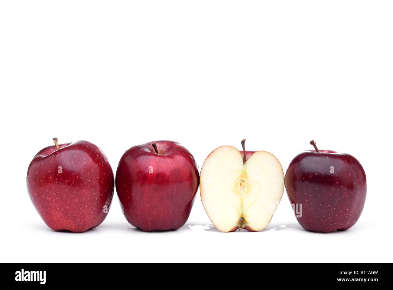 Red apples line up on a white background with one sliced apple Stock ...