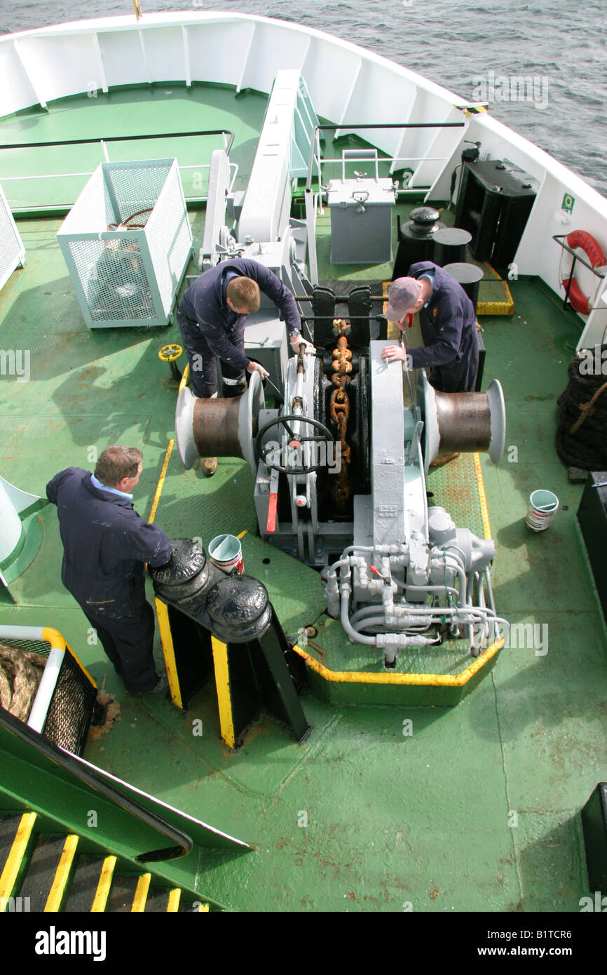 DECKHANDS SERVICING AN ANCHOR WINCH ON THE DECK OF THE FERRY MV ...