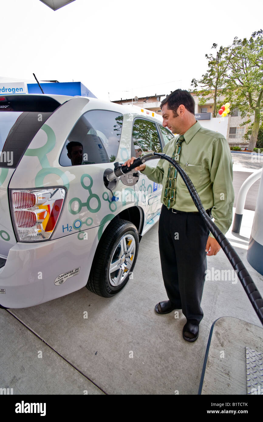 Driver at a hydrogen pump at a Los Angeles gas station prepares to ...