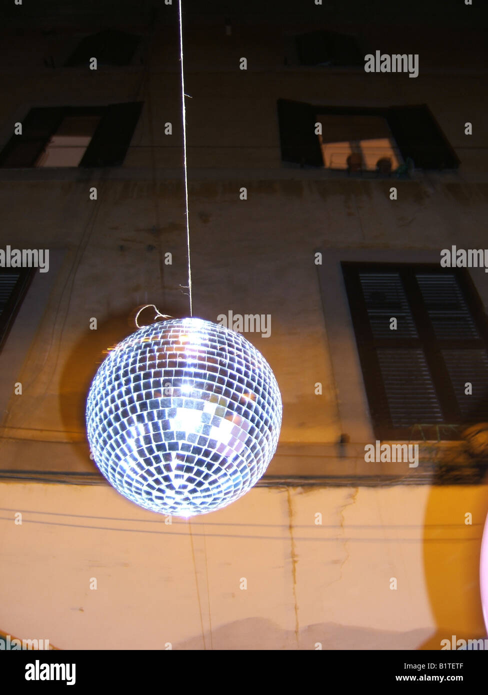 one illuminated glitter ball street party at night Stock Photo - Alamy