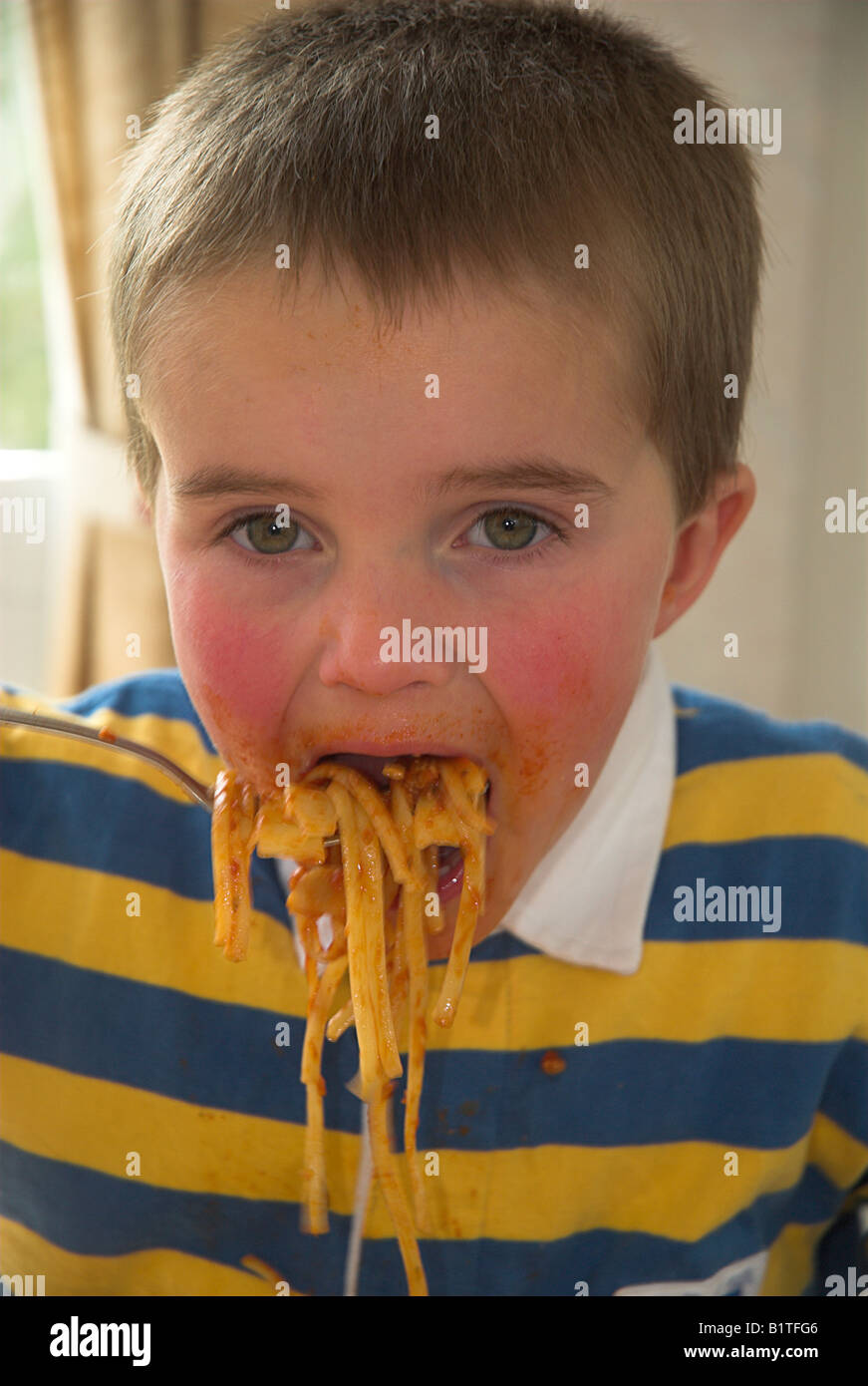Boy Getting in a Mess Eating Spaghetti Bolognese Stock Photo - Alamy
