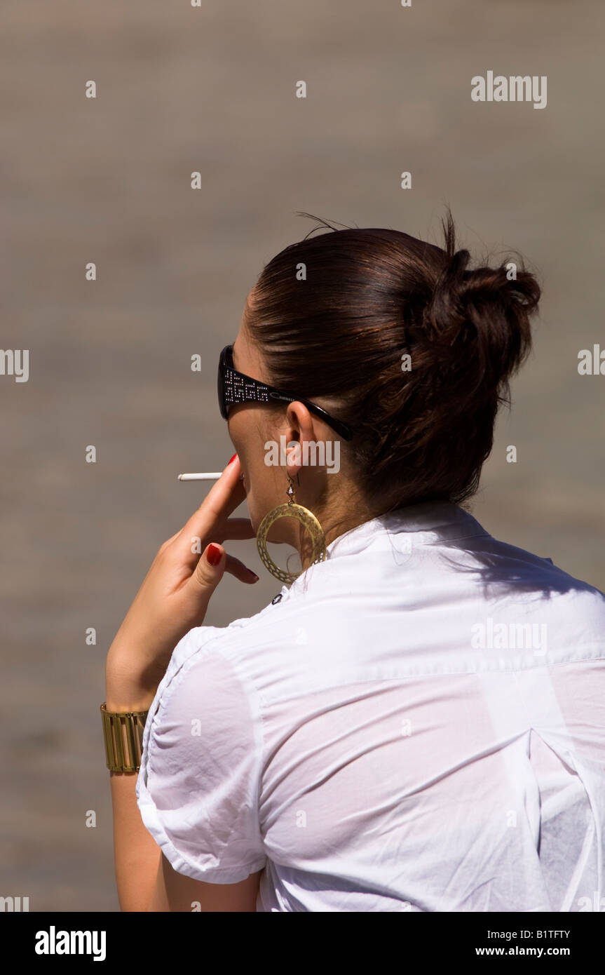 Lone woman smoking cigarette Old Town Poznan Poland Stock Photo - Alamy