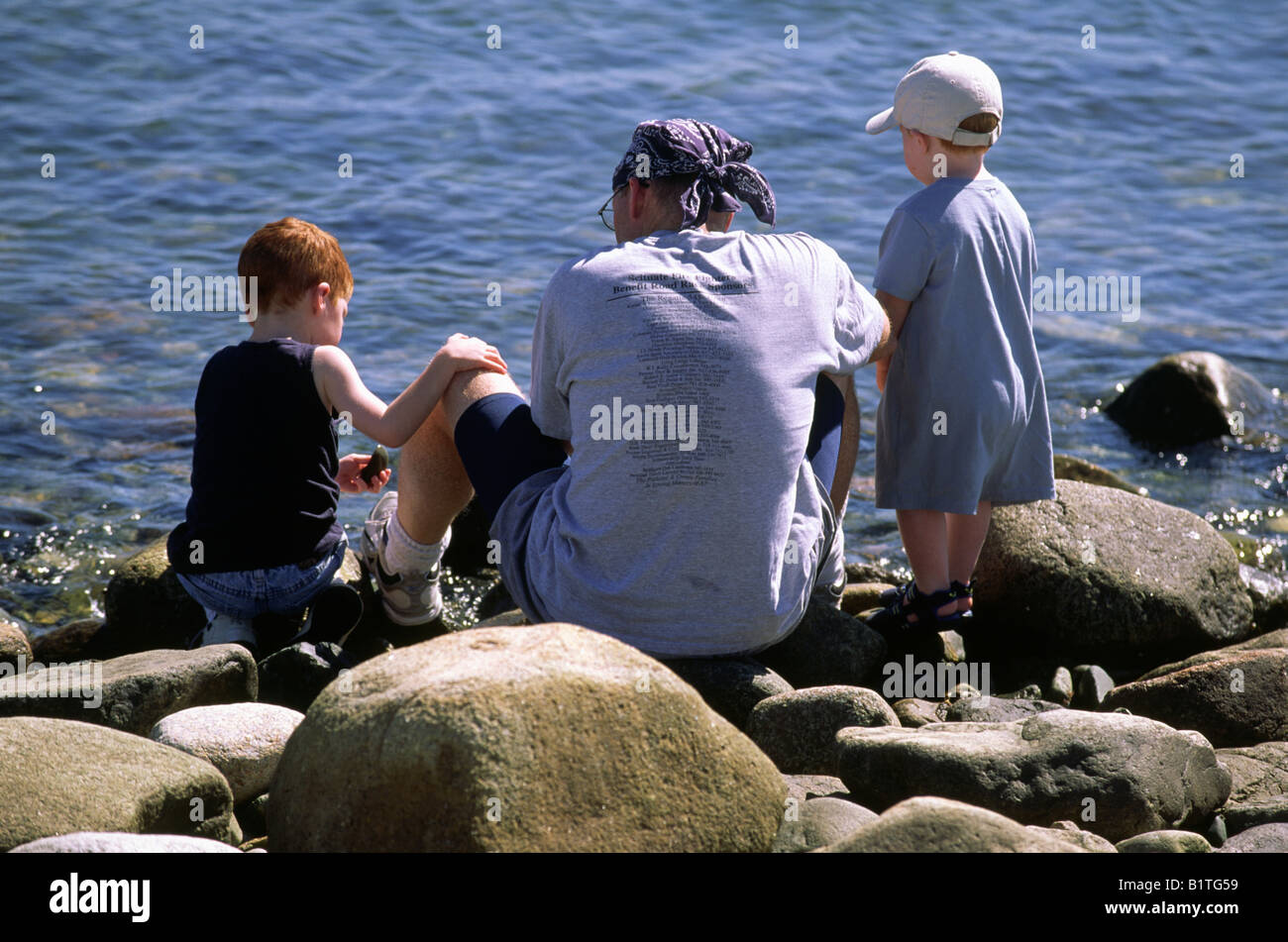 Father, two sons, seashore Stock Photo - Alamy