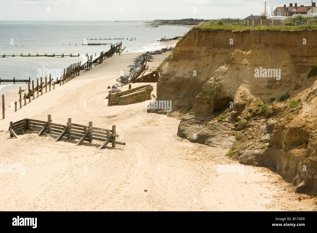 Remains old sea defences and houses on cliff edge after severe coastal ...