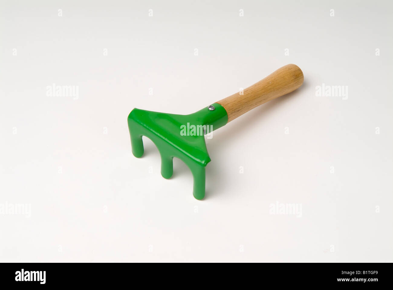 green rake kids garden tool Stock Photo - Alamy