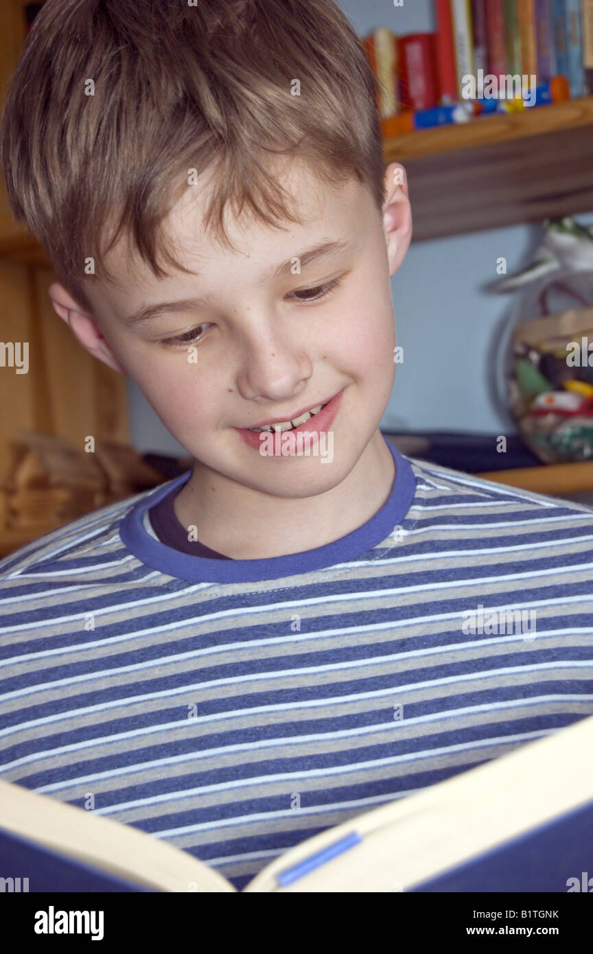 Boy reading book Stock Photo - Alamy