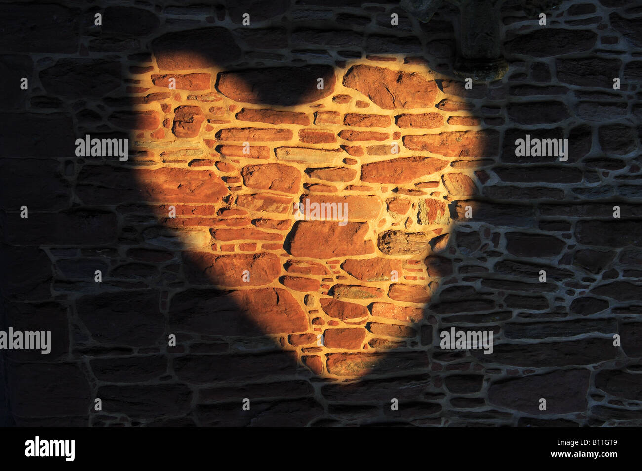 Heart shaped light on wall Stock Photo - Alamy