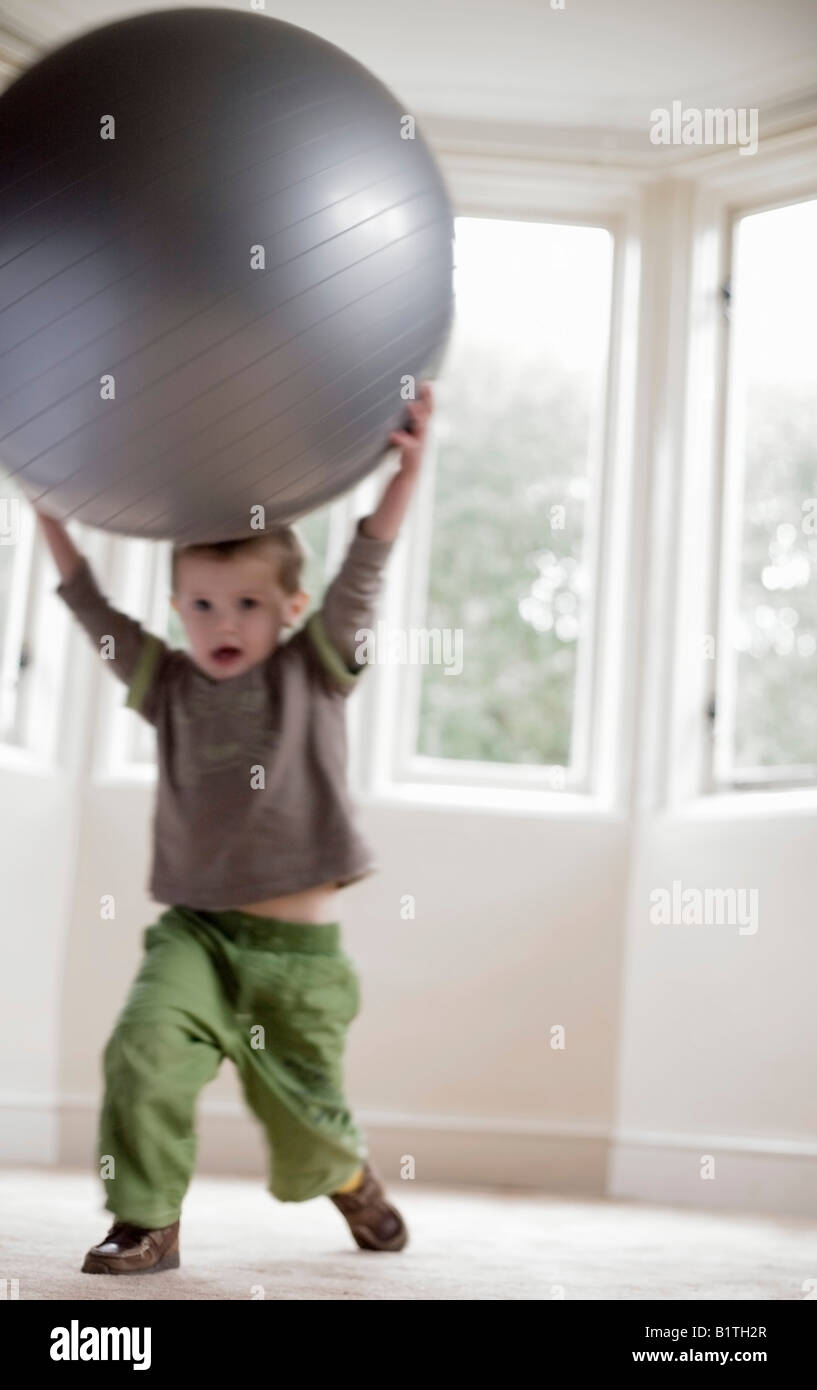 Child Holding Giant Ball Above Head Stock Photo - Alamy