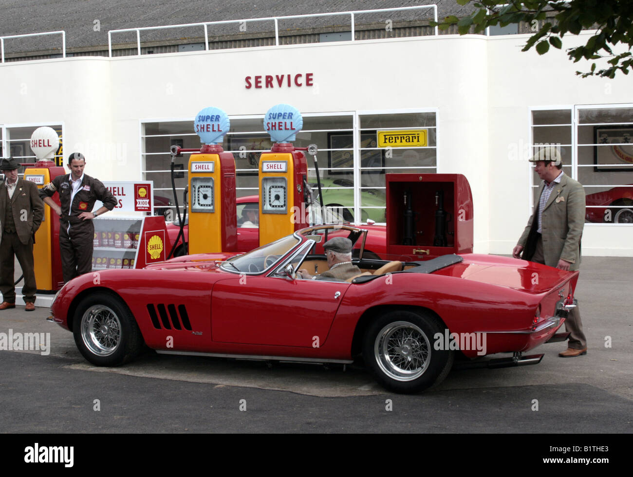 Murray Walker carefully pulls up in his red Ferrari 275GTB at the Super ...