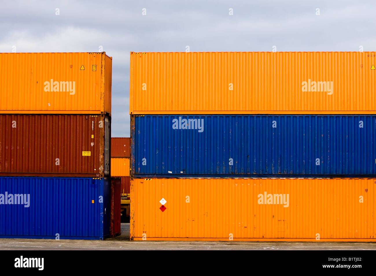 International shipping containers are stacked at an intermodal yard in ...