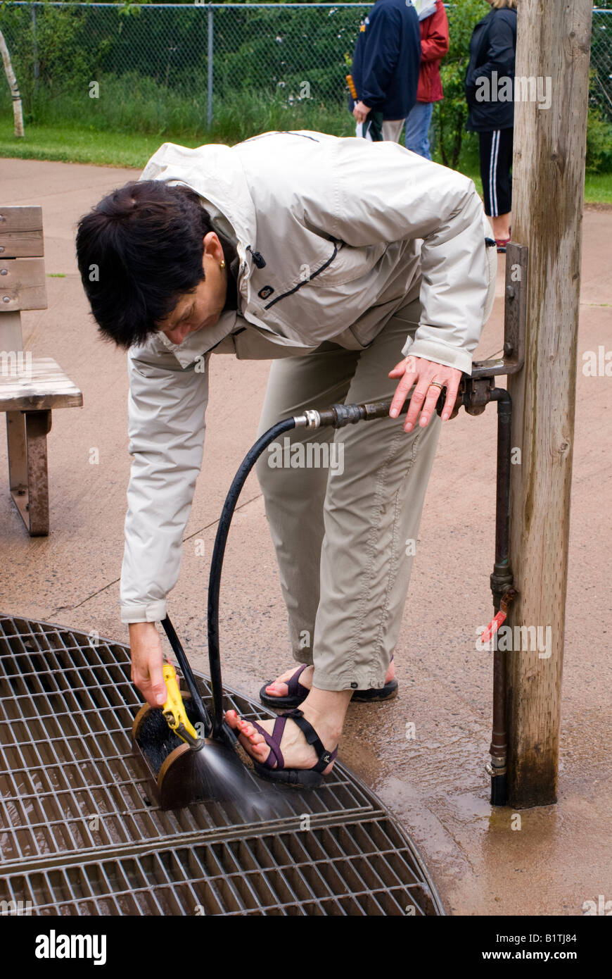 washing muddy feet Hopewell Rocks New Brunswick Stock Photo - Alamy