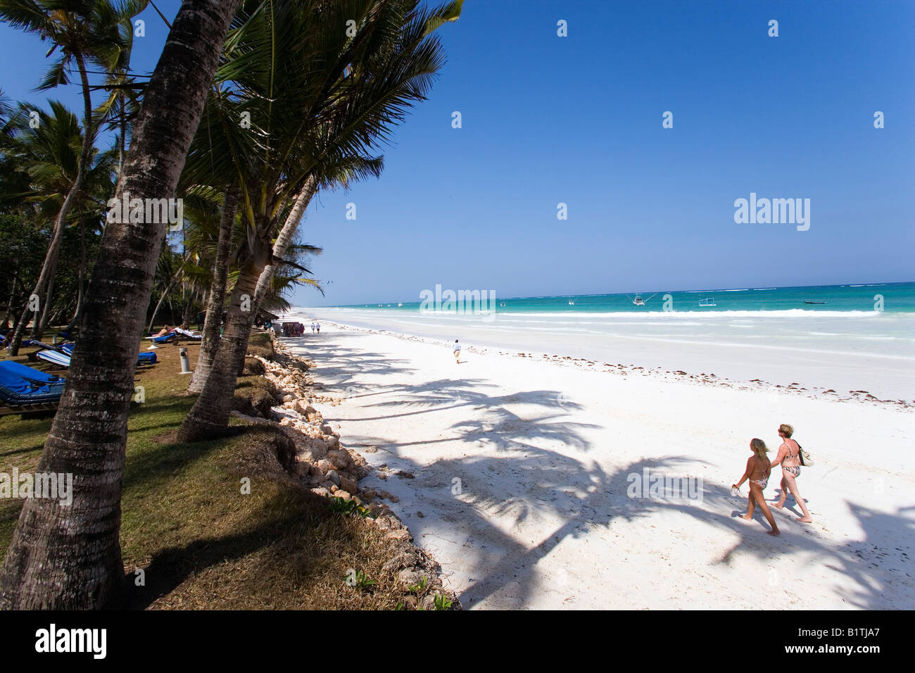 Women walking along Diani Beach Coast Kenya Stock Photo - Alamy