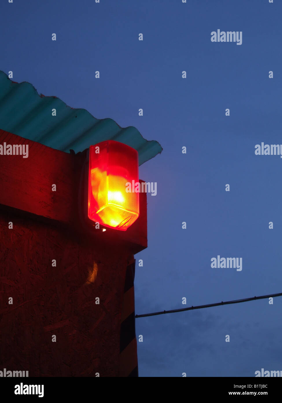 one security light on building at night Stock Photo - Alamy