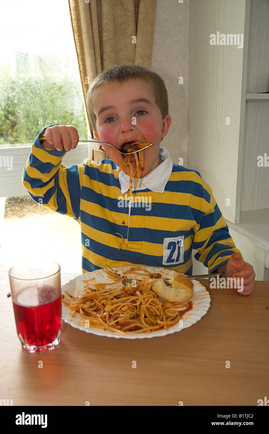 Boy Getting in a Mess Eating Spaghetti Bolognese Stock Photo - Alamy