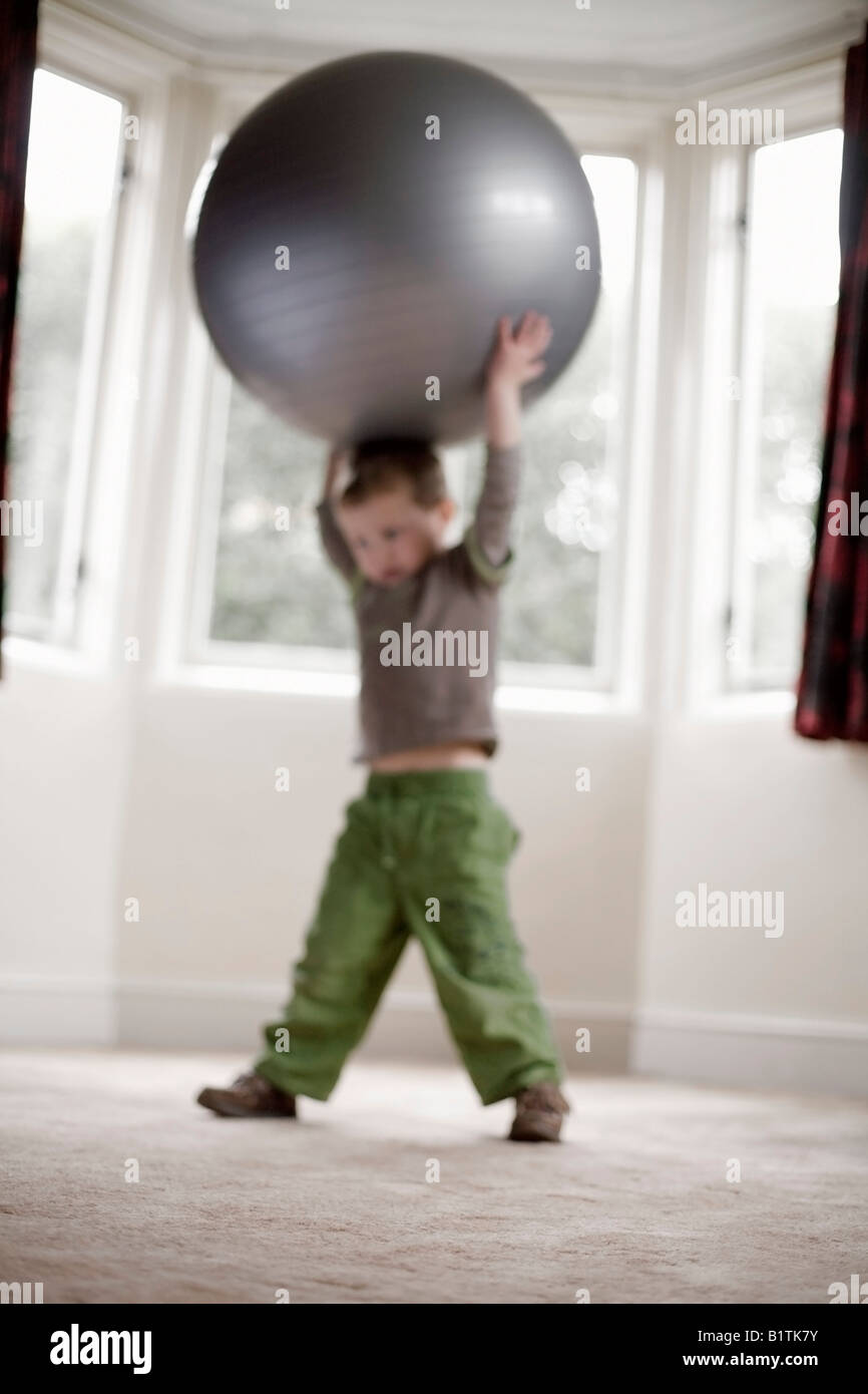Child Holding Giant Ball Above Head Stock Photo - Alamy