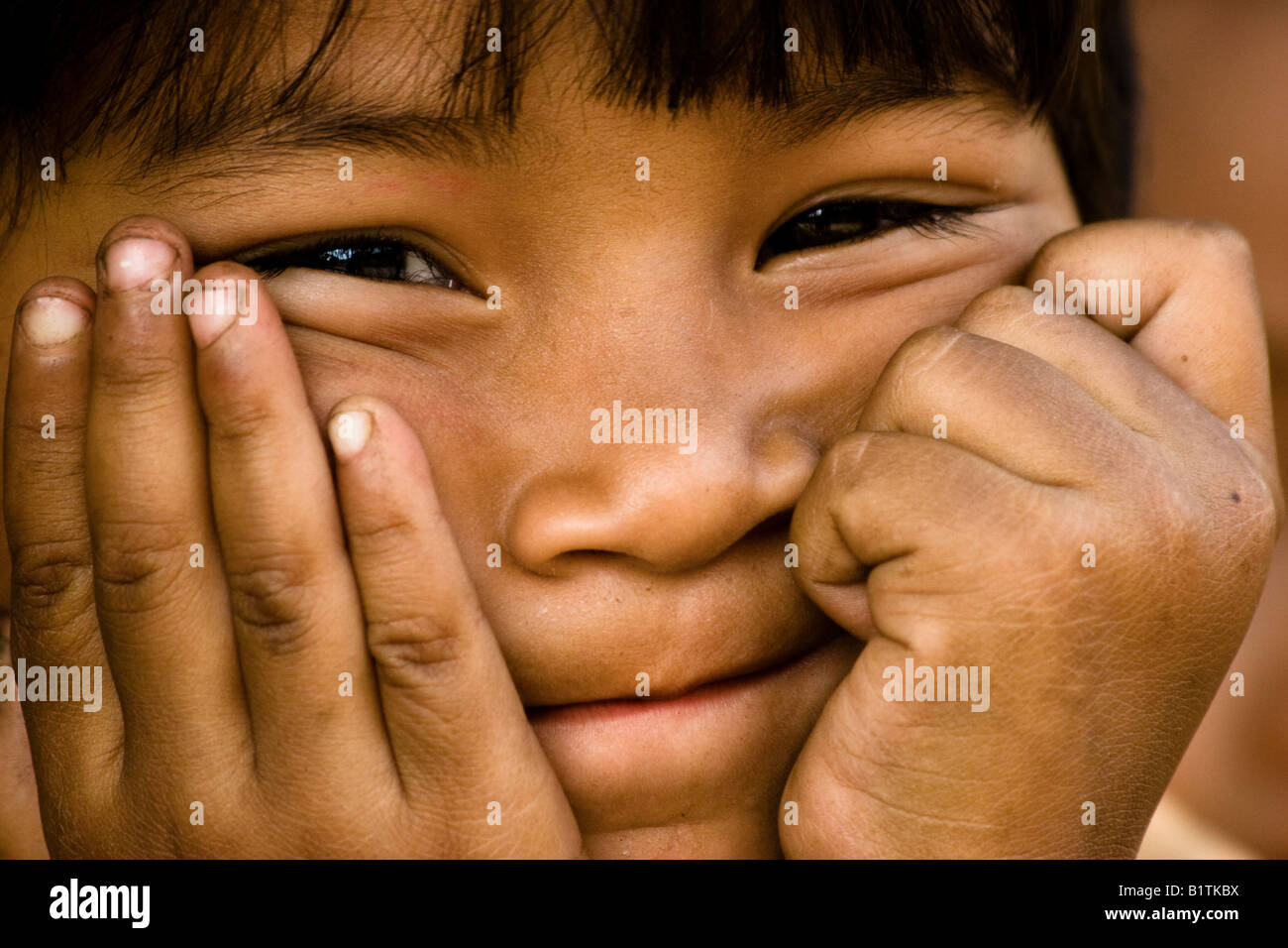 A young Burmese boy in the border town of Tachilek stares bemusedly ...