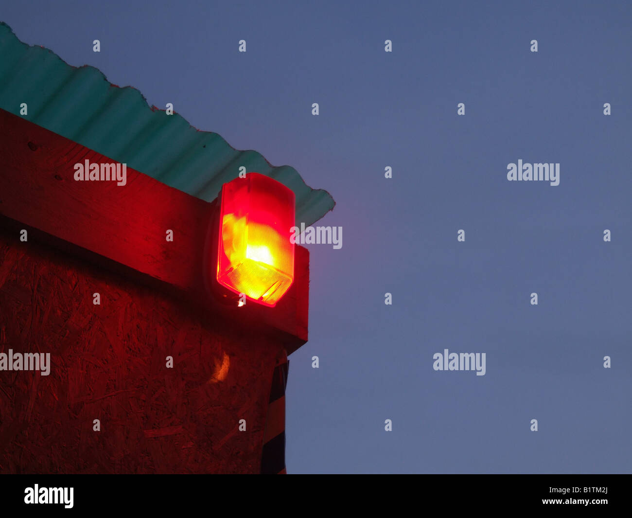 one security light on building at night Stock Photo - Alamy