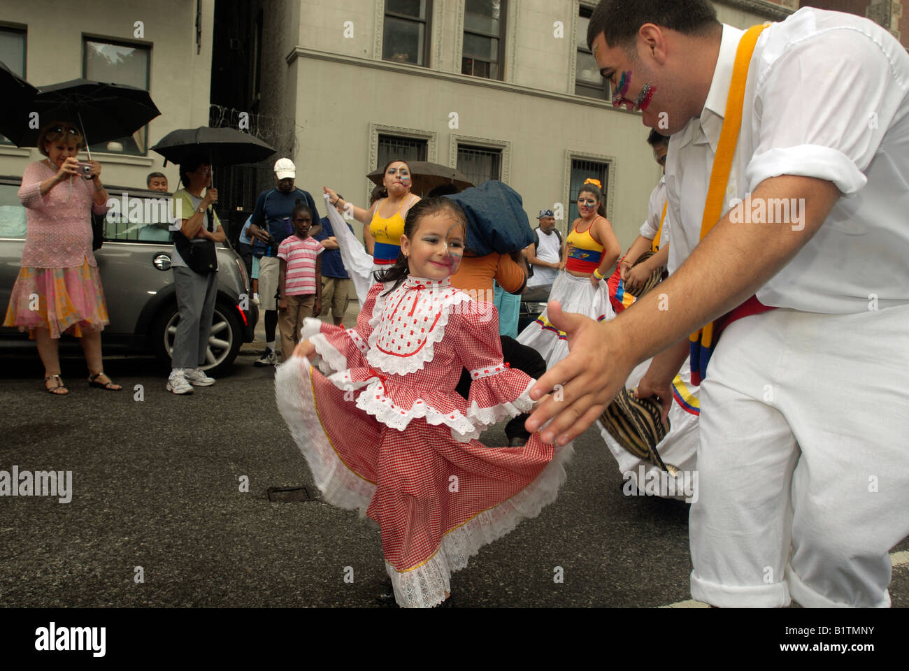 Colombian folk dancers perform in a flower parade on Central Park West ...