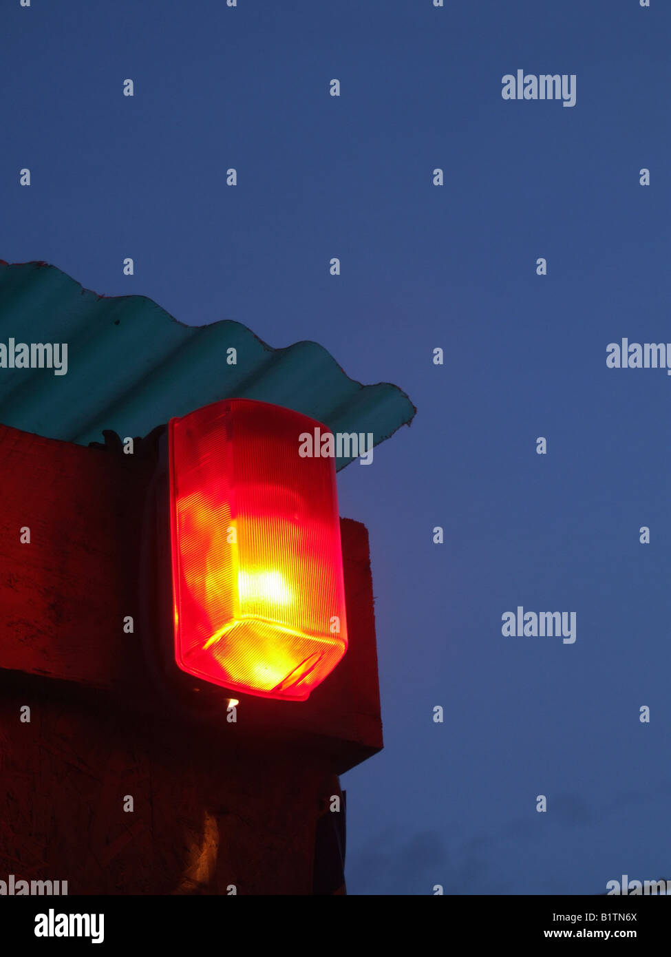 one security light on building at night Stock Photo - Alamy