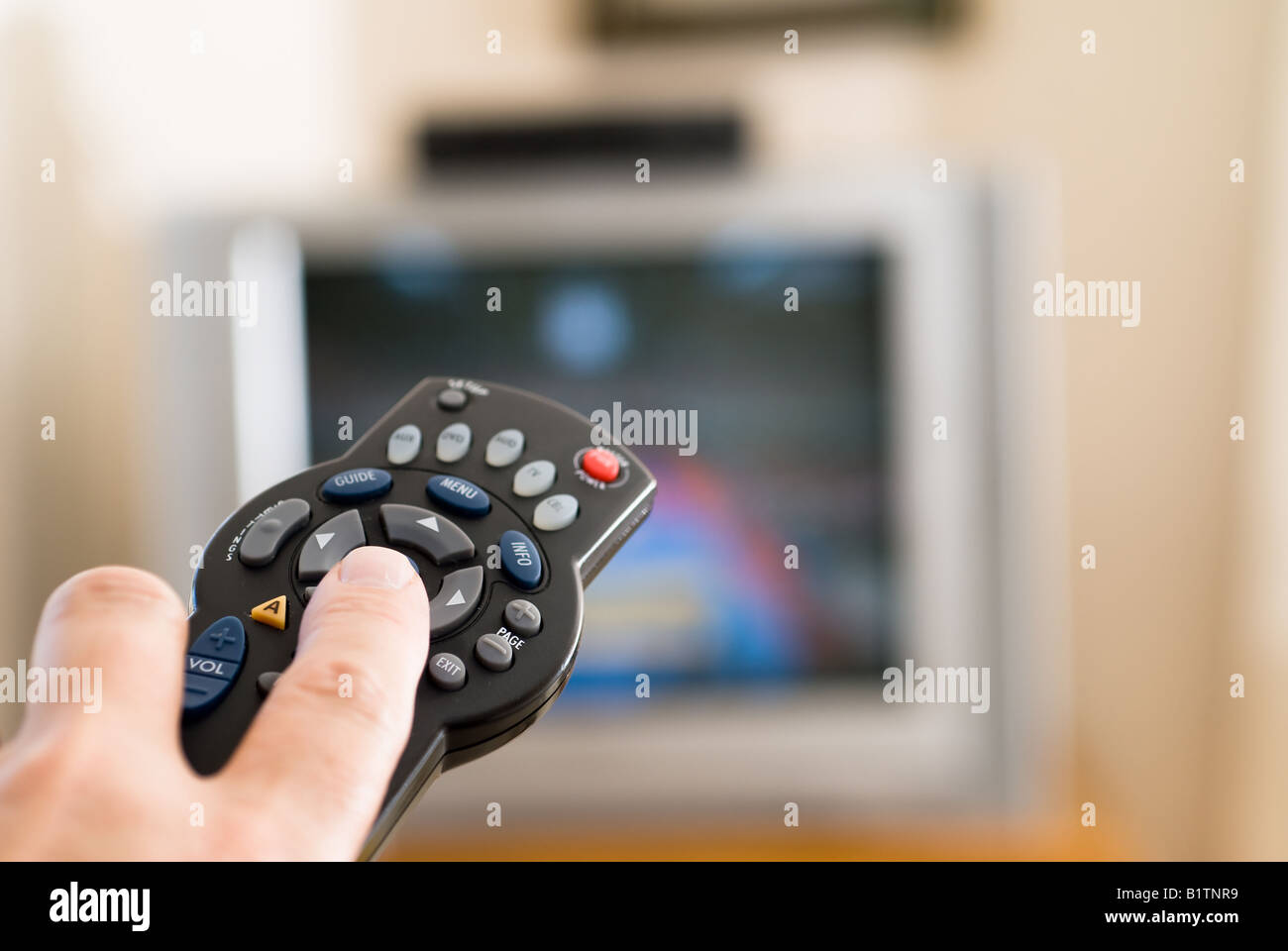 A man changes the channels on his television Stock Photo - Alamy