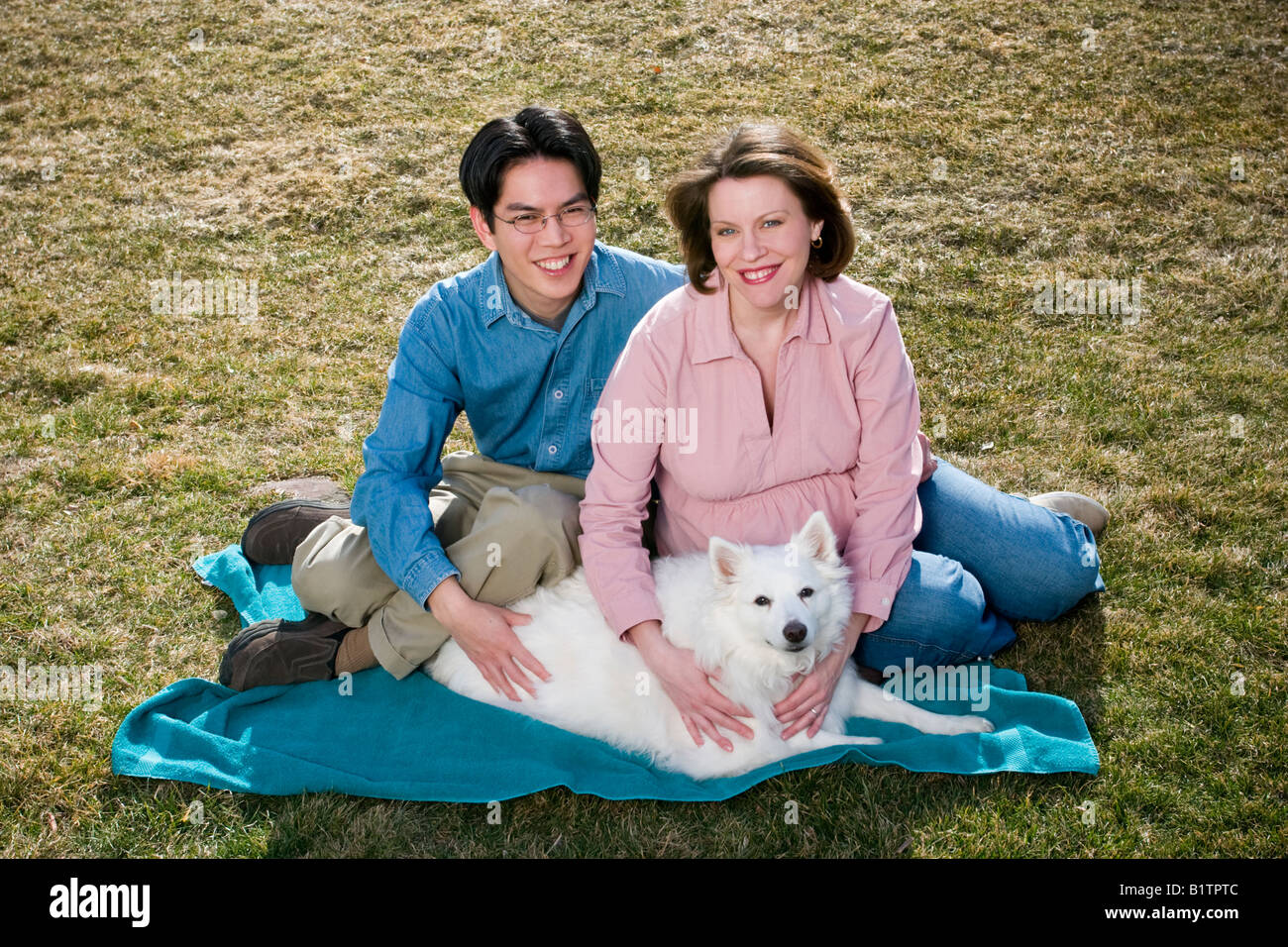 Young Married Couple Asian Man With Glasses And Pregnant Caucasian