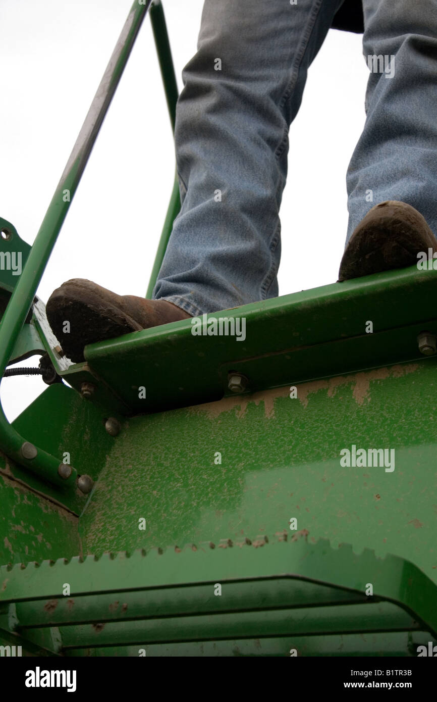 Farmer s boots stepping out of the cabin of the combine Stock Photo - Alamy