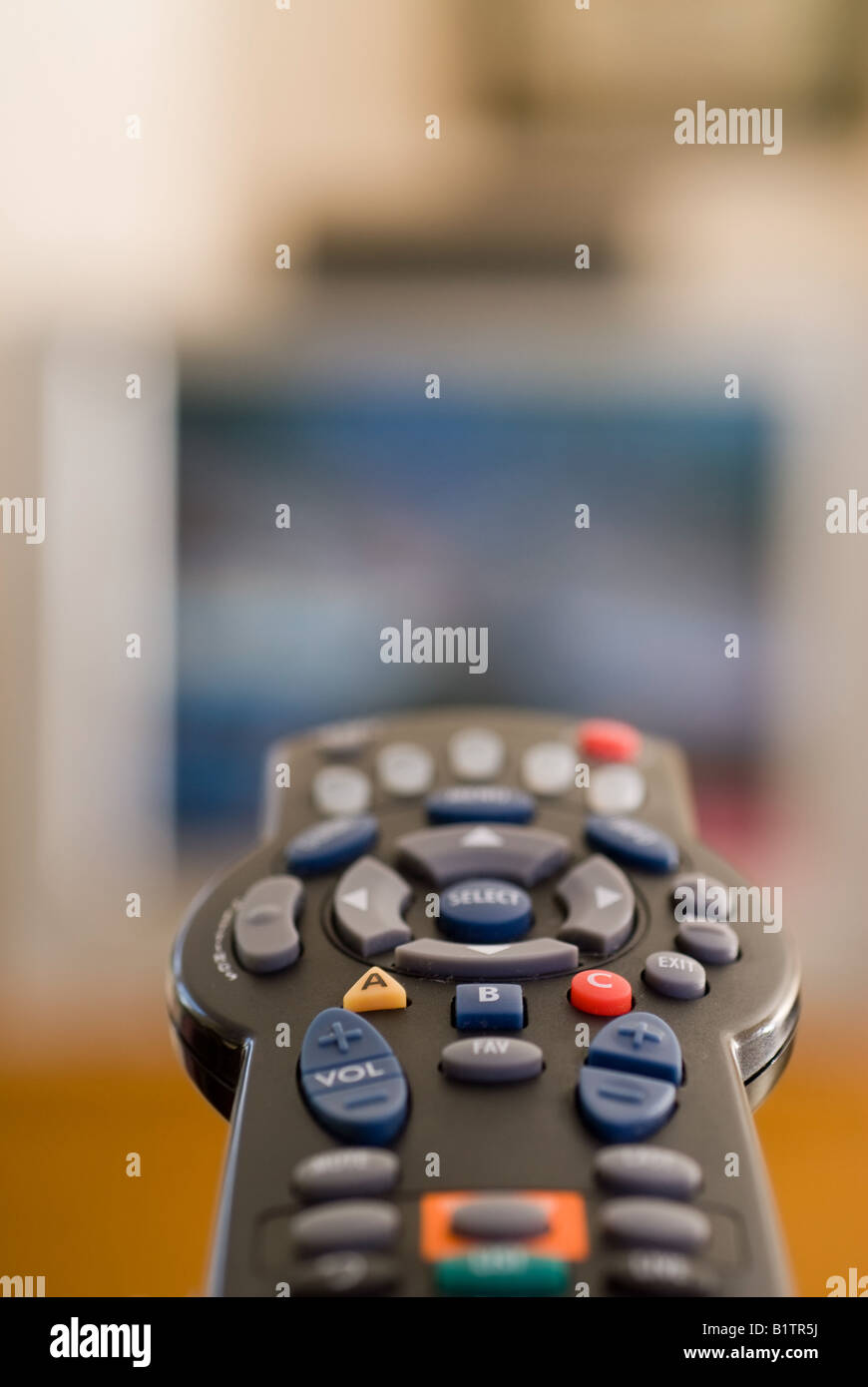 A remote control pointed towards a TV shows the concept of the couch ...