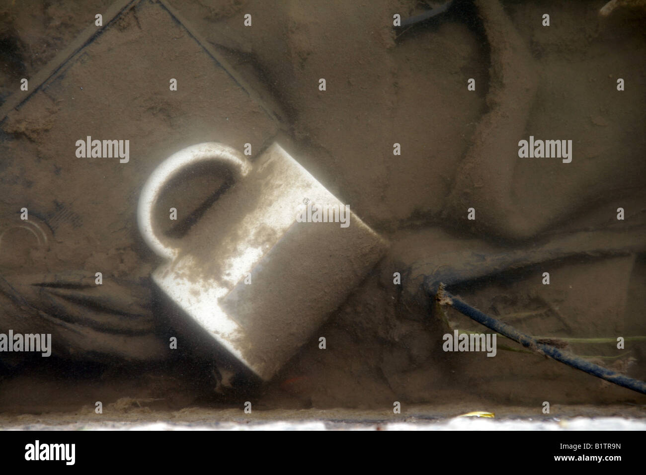 one single mug cup in dirty muddy river Stock Photo - Alamy
