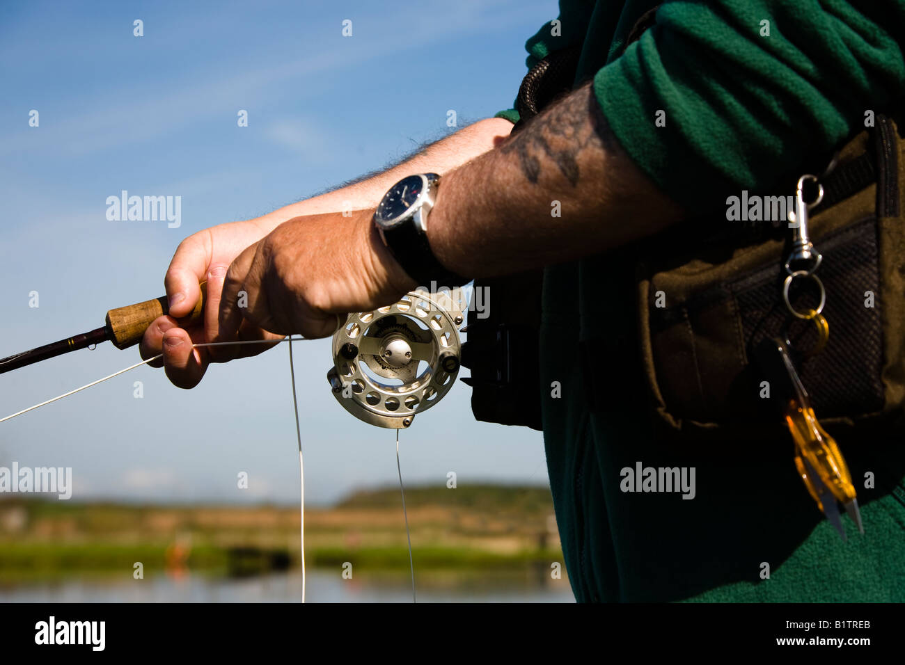 man fishing for trout using rod and line, near Symington, Ayrshire ...