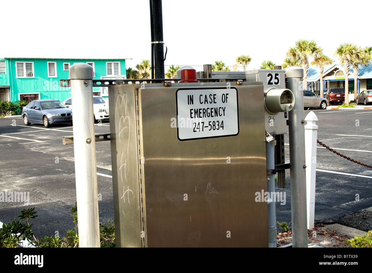 Electric power box with emergency sign on the front by a parking lot in ...