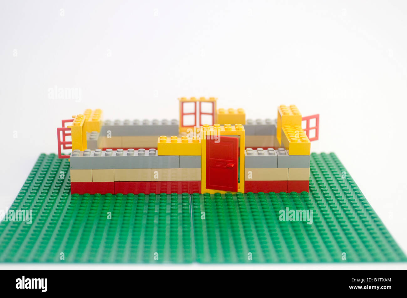 Lego House construction process on white background Stock Photo - Alamy