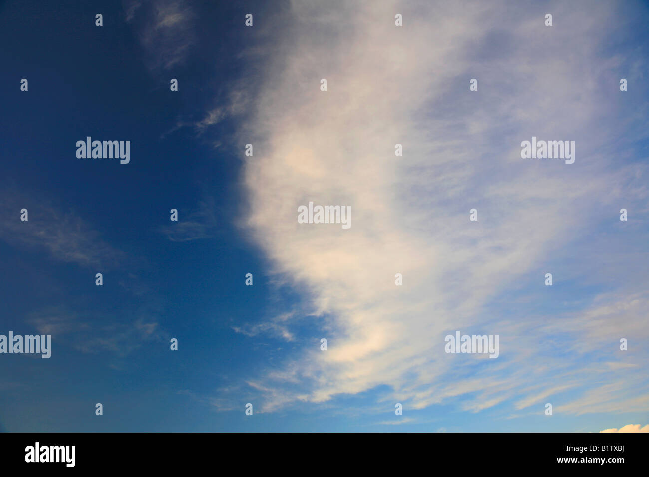 Cirrus Uncinus clouds in a deep blue polarised sky England Britain UK ...