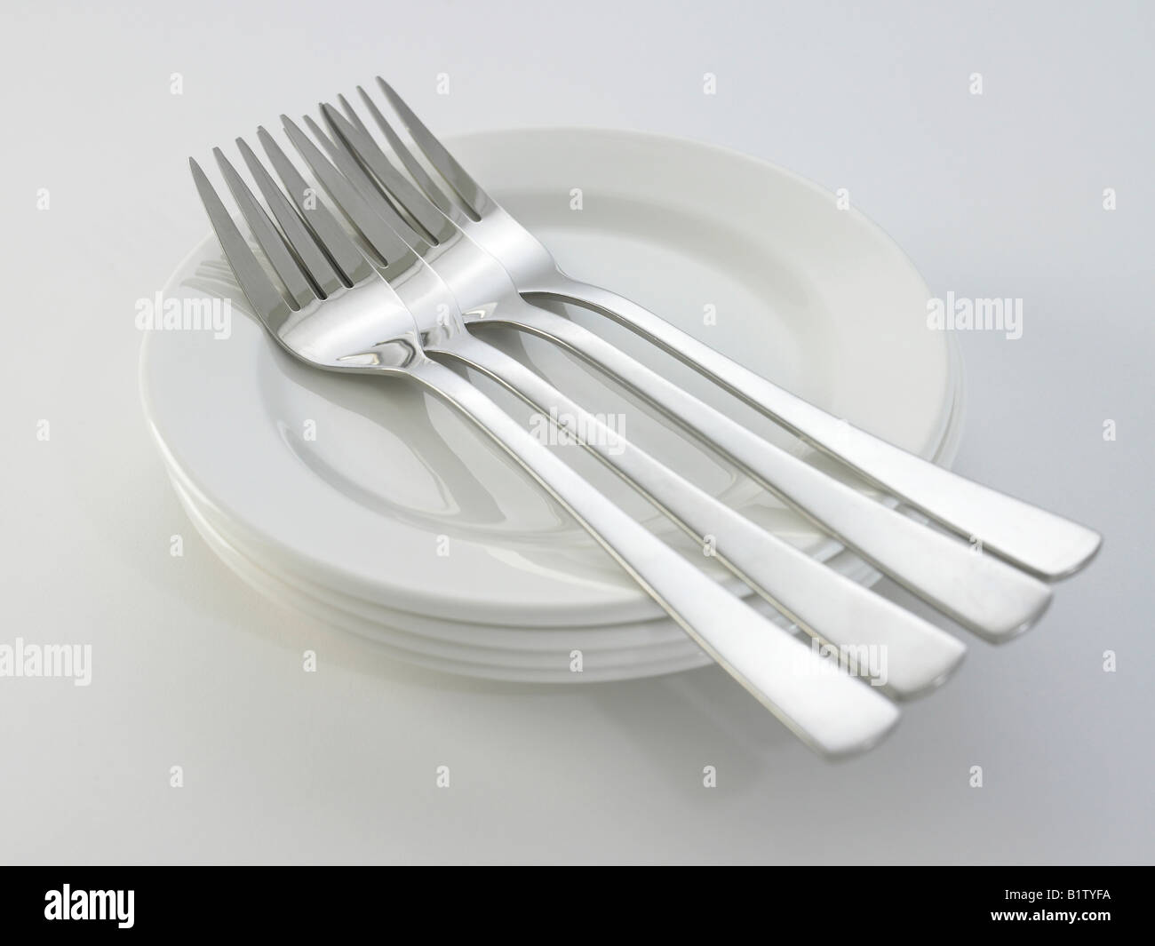 side plates and dessert forks Stock Photo - Alamy
