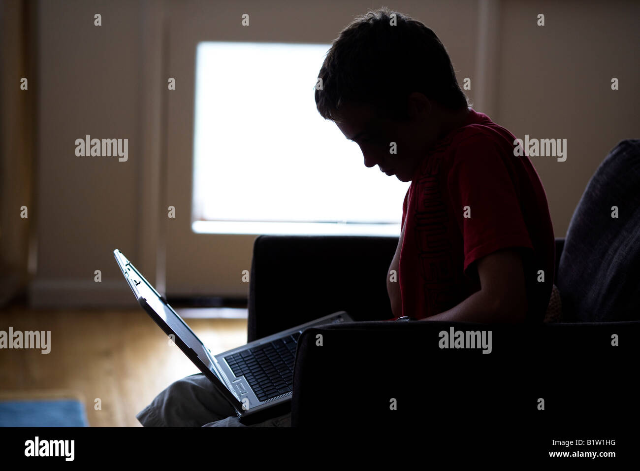 teenage boy working on laptop computer Stock Photo - Alamy