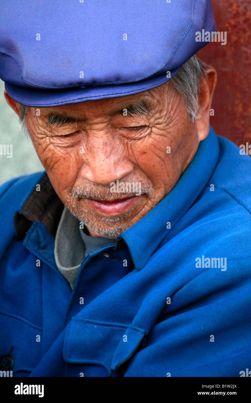 Portrait of a man playing a board game in the old town, Jianshui ...