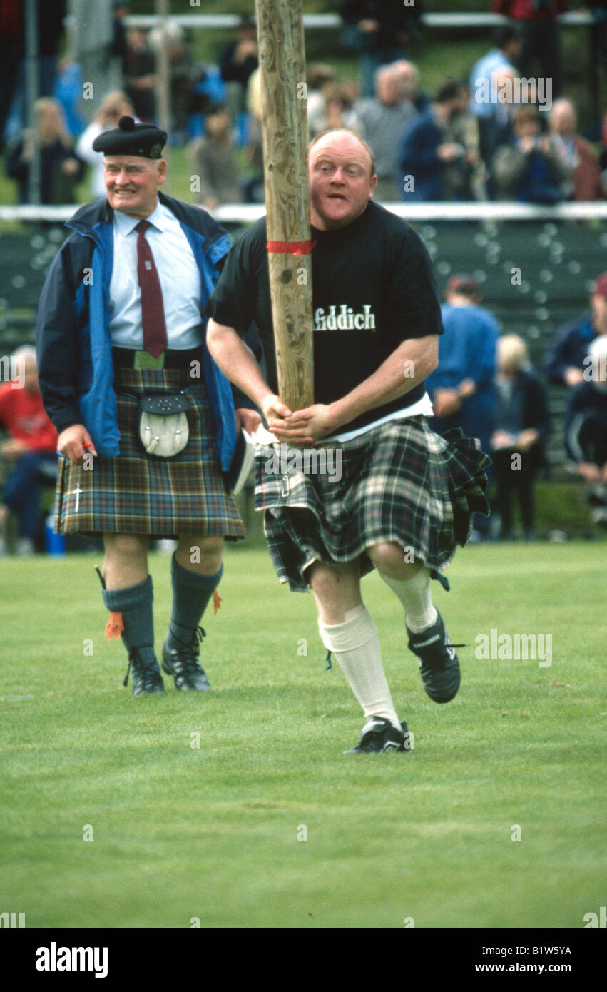 Competitor 'Tossing the Caber' event at a traditional scottish highland ...