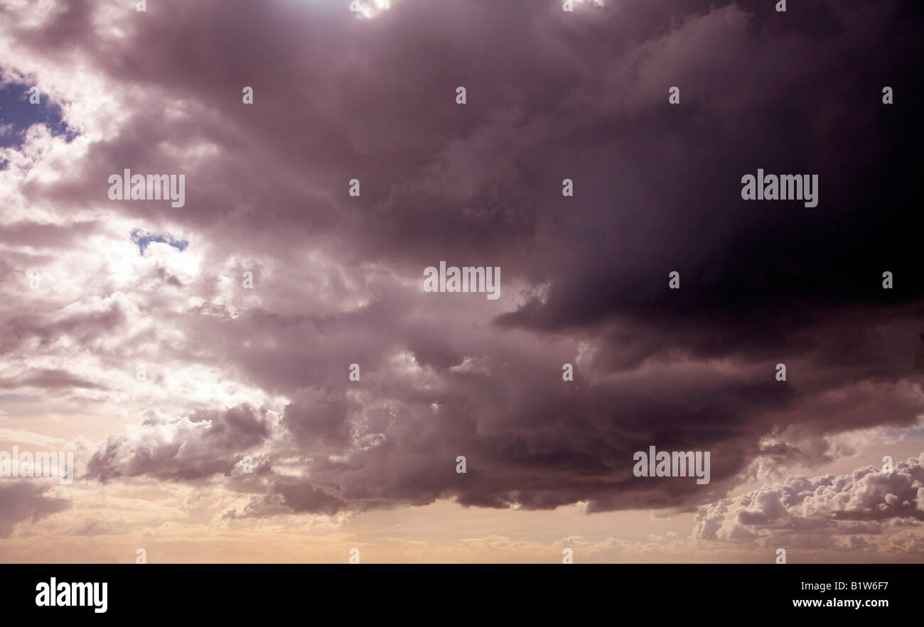 Big dark brooding black storm cloud moving in on a rich blue sky Stock ...