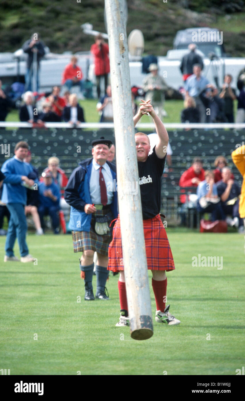 Competitor 'Tossing the Caber' event at a traditional scottish highland ...