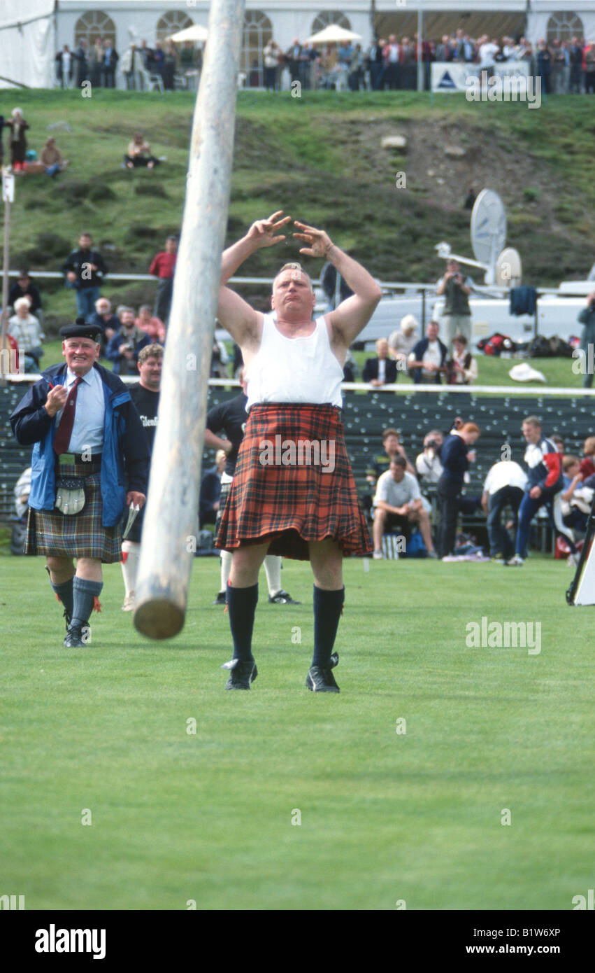 Competitor 'Tossing the Caber' event at a traditional scottish highland ...