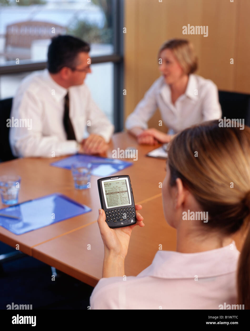 woman with mobile phone at business meeting Stock Photo - Alamy
