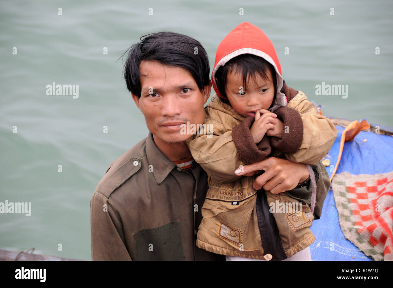 Vietnamese father and son who live and work from boats Ha Long Bay ...