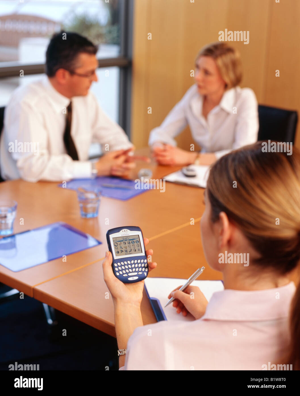 woman with mobile phone at business meeting Stock Photo - Alamy