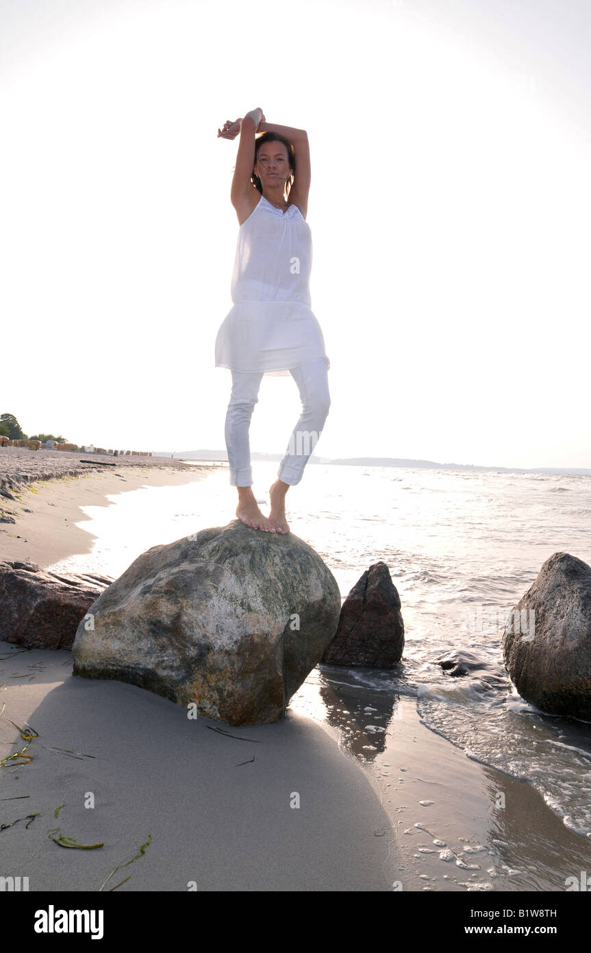 young woman 24 relaxing at beach, sunset, backlight, free, easy, happy ...