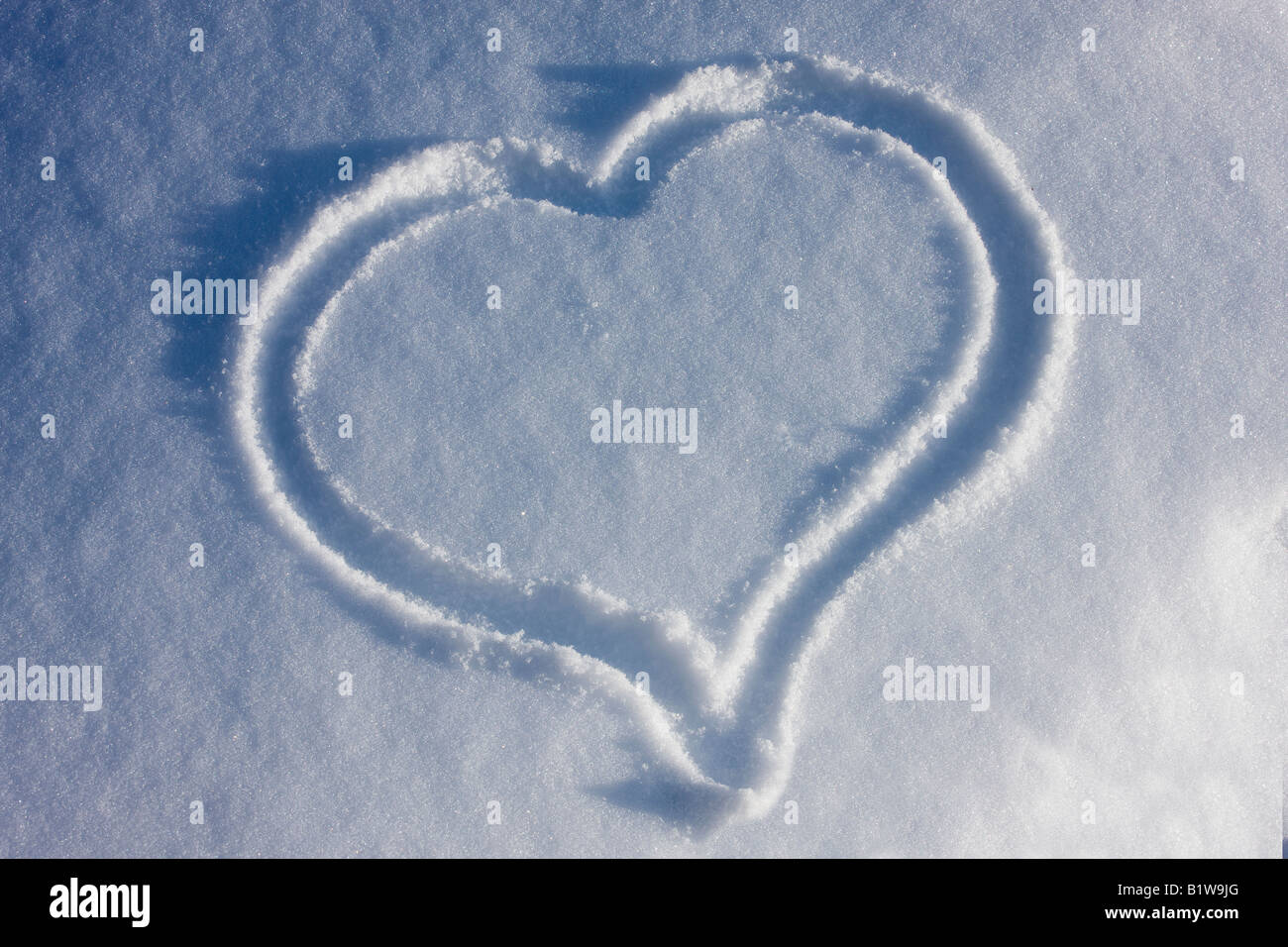 Love heart carved in snow Stock Photo - Alamy