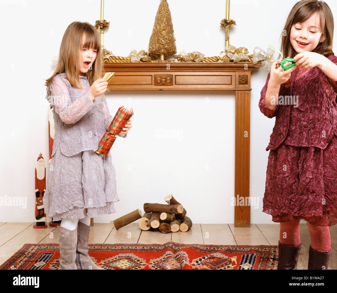 Children opening Christmas crackers in front of Fireplace Stock Photo ...