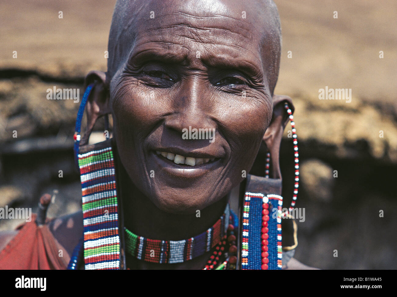 Maasai woman in traditional dress wearing ear ornaments of beaded ...